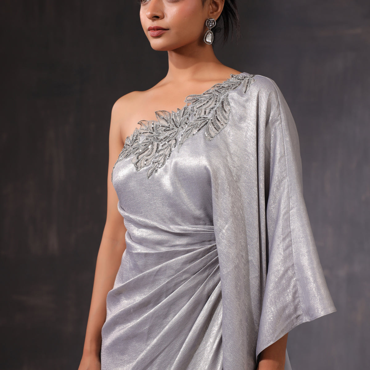 GREY SHIMMER ONE SHOULDER DRAPED GOWN WITH 3D APPLIQUE WORK – K.Anshika
